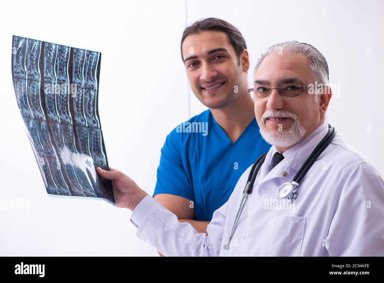 Two male doctors working in the modern clinic Stock Photo - Alamy