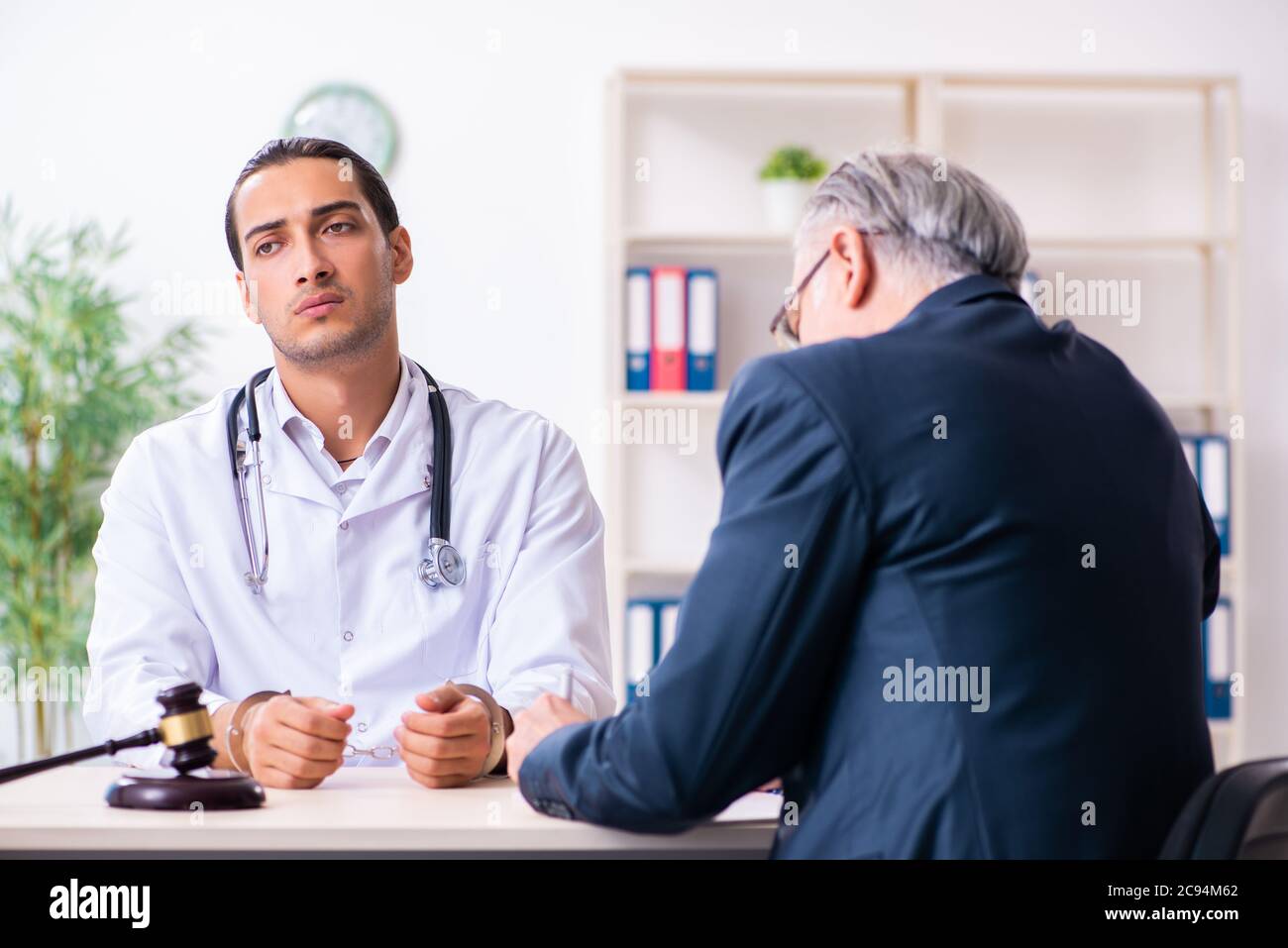 Doctor in courthouse meeting with lawyer Stock Photo - Alamy