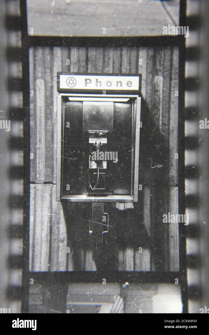 Fine 1970s vintage black and white photography of a public telephone ...