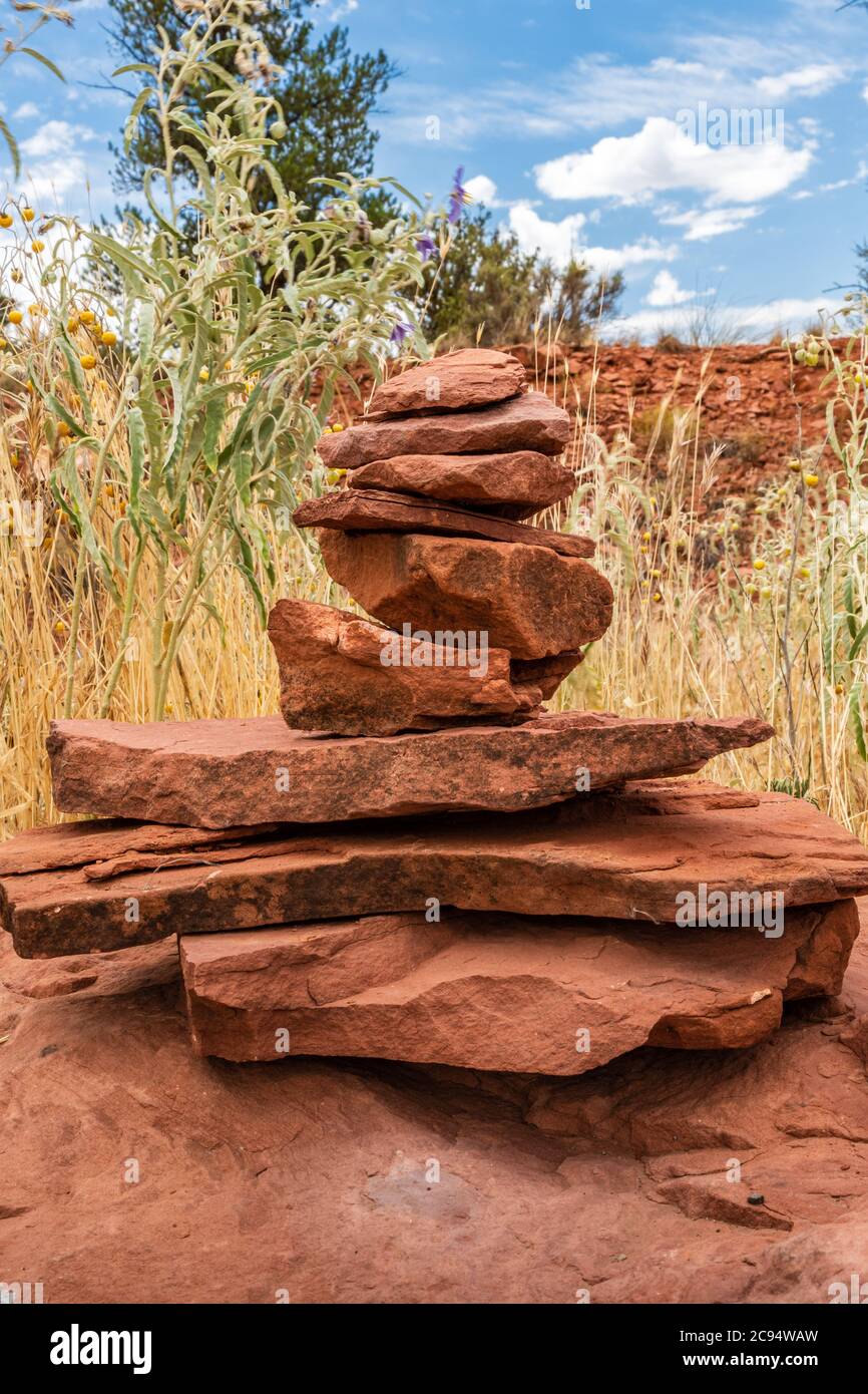 Balance and wellness concept. Close-up of a stack of rough red rocks ...
