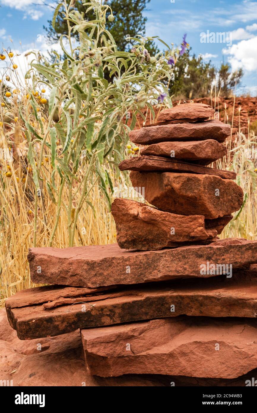 Balance and wellness concept. Close-up of a stack of rough red rocks ...
