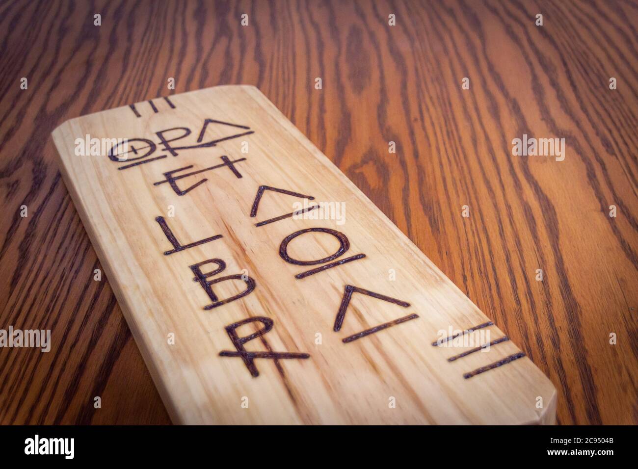 Photograph of a handcraft of aa latin phrase on wood, that means: Pray ...
