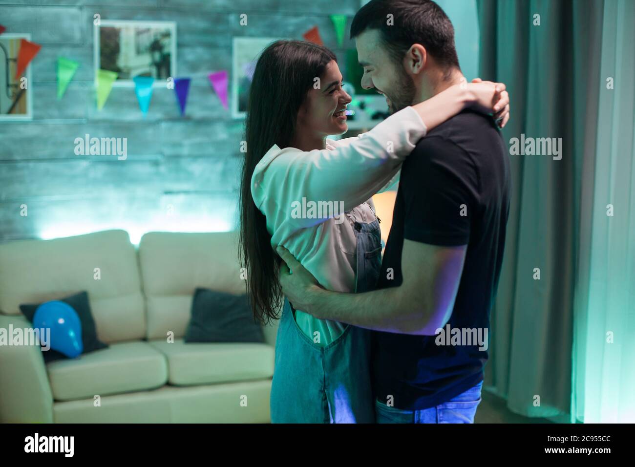 Loving young couple having fun dancing at friends party Stock Photo - Alamy