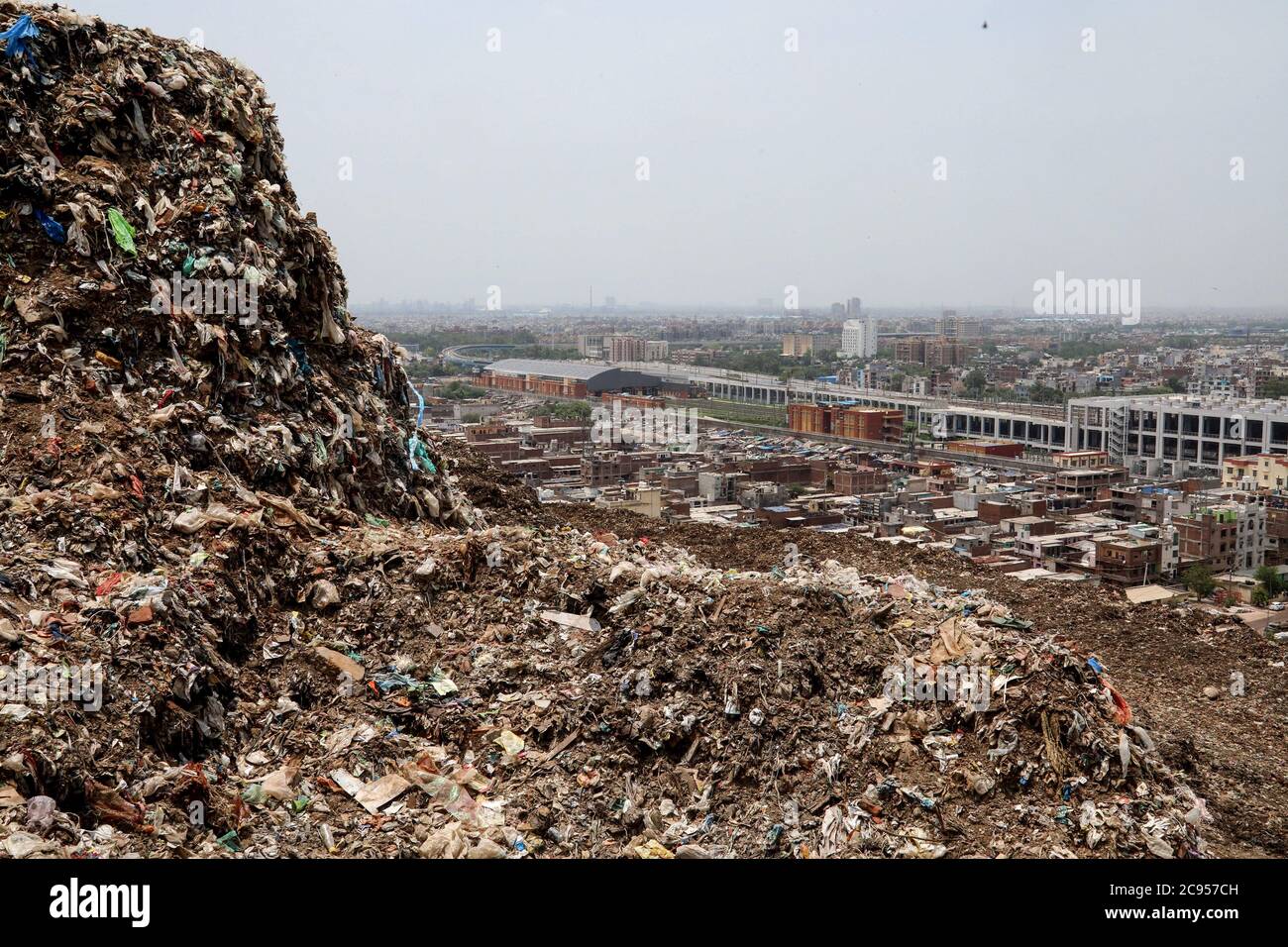 New Delhi, India. 28th July, 2020. A view from the Ghazipur landfill site with high rise city ...