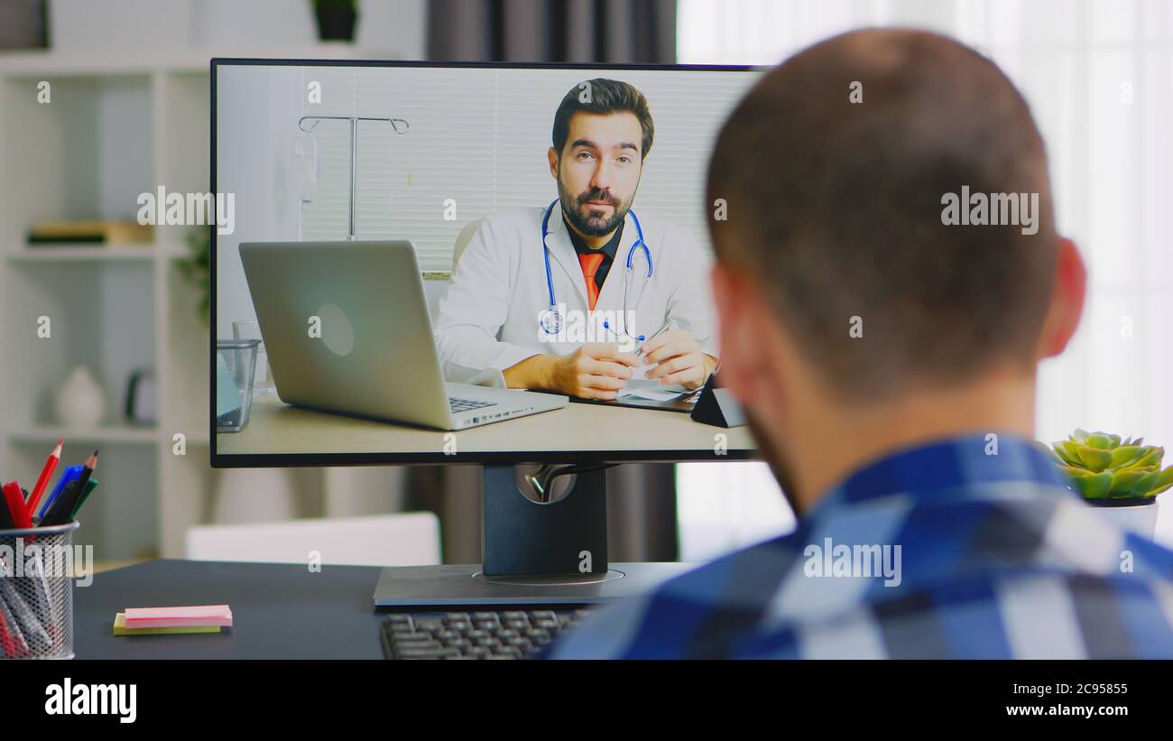 Patient on video call with doctor talking about his rehabilitation ...