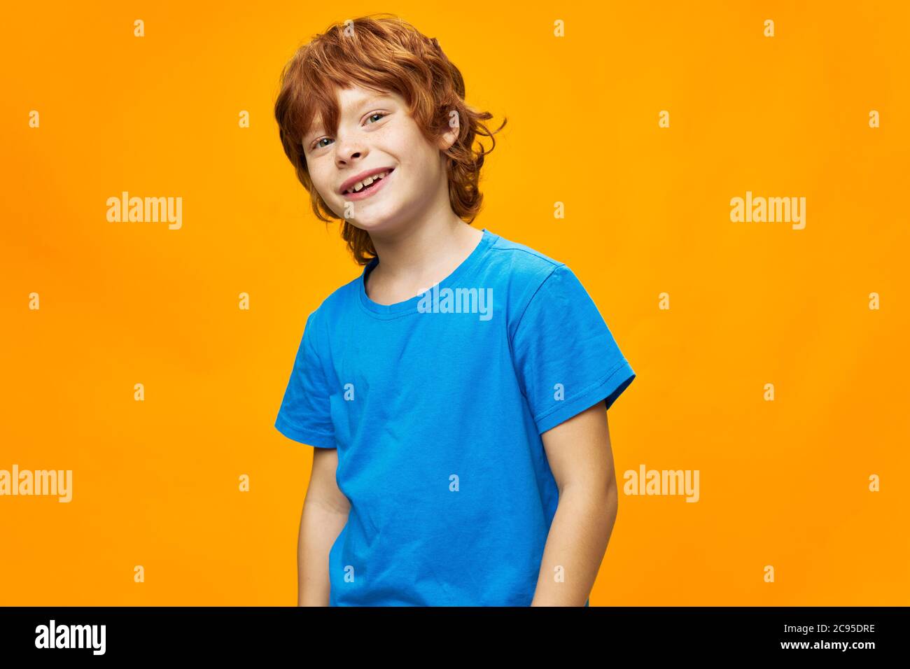 Cheerful little child boy smile side view blue t-shirt yellow ...
