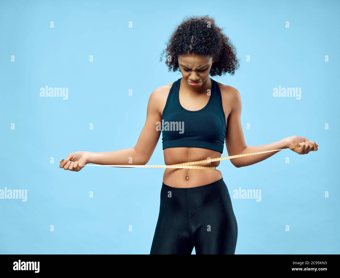 Sporty woman slim figure measuring tape workout Stock Photo - Alamy