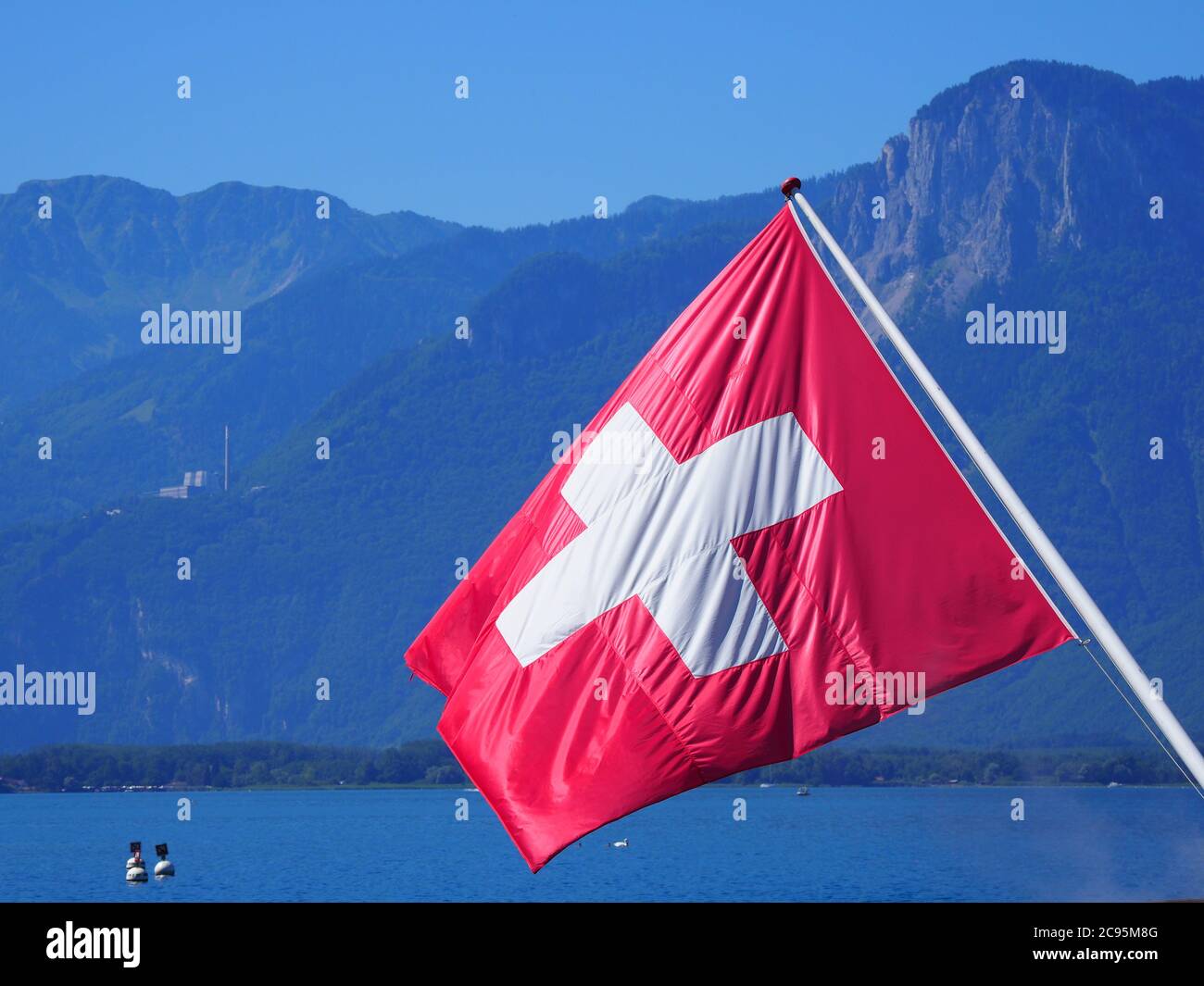 Red and white Swiss national flag at Lake Geneva in Switzerland Stock ...