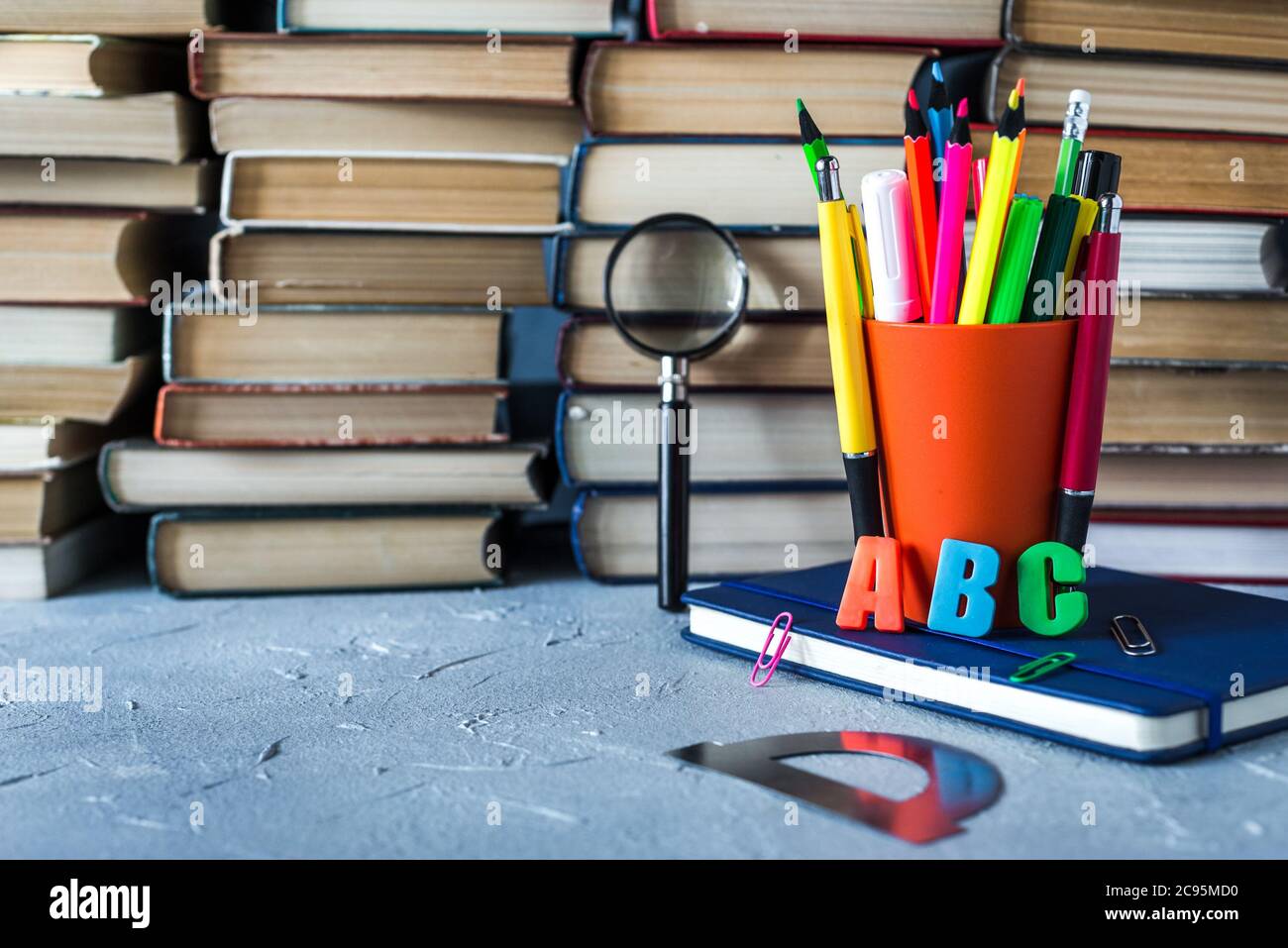 A stack of books and pencils on a desk in elementary school. A stack of ...