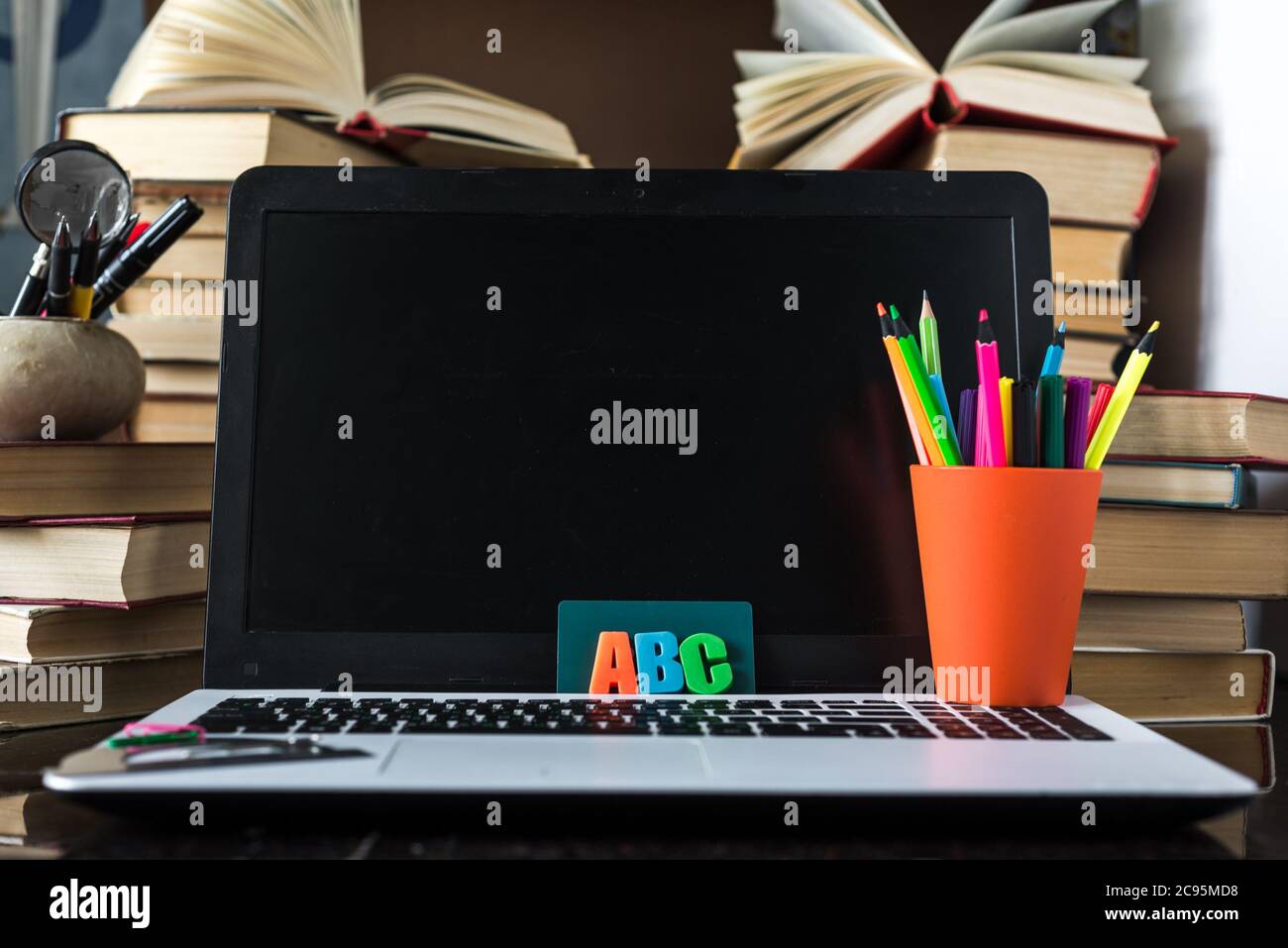 A stack of books and pencils on a desk in elementary school. A stack of ...