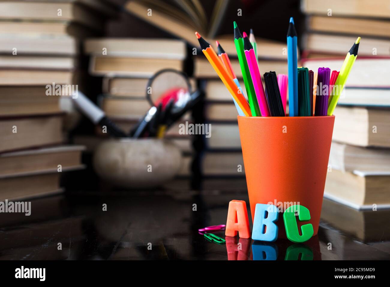 A stack of books and pencils on a desk in elementary school. A stack of ...