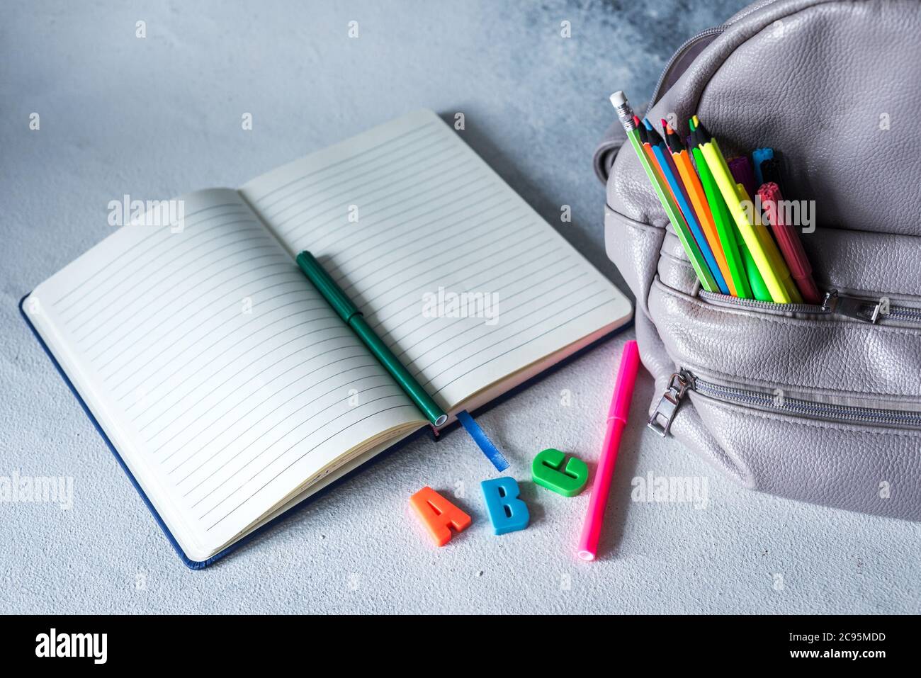 A stack of books and pencils on a desk in elementary school. A stack of ...