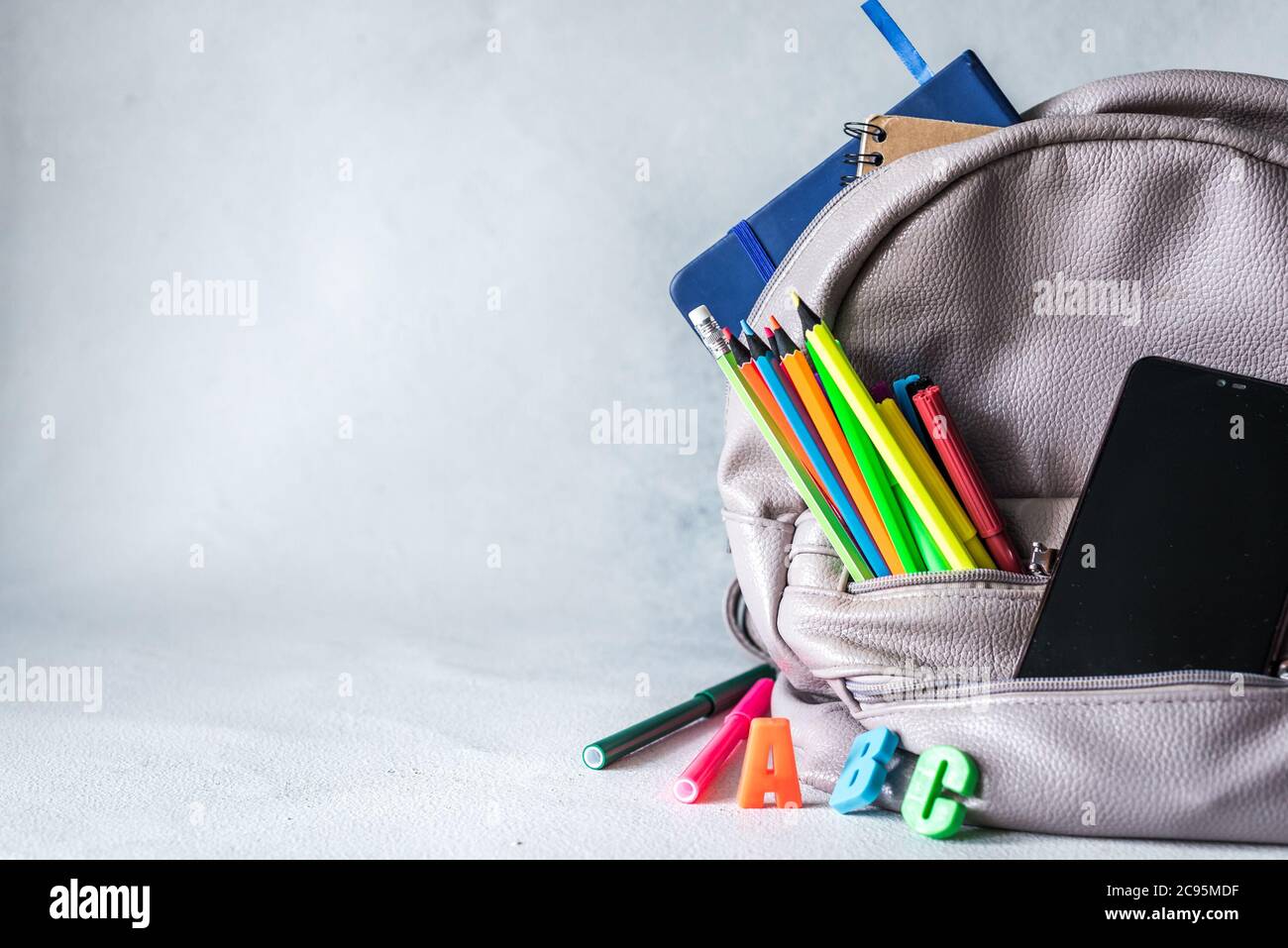 A stack of books and pencils on a desk in elementary school. A stack of ...