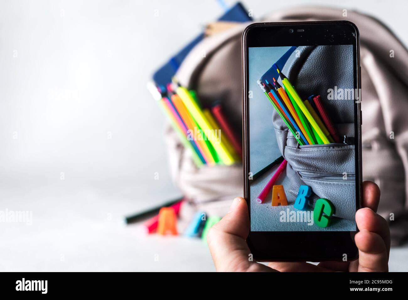 A stack of books and pencils on a desk in elementary school. A stack of ...