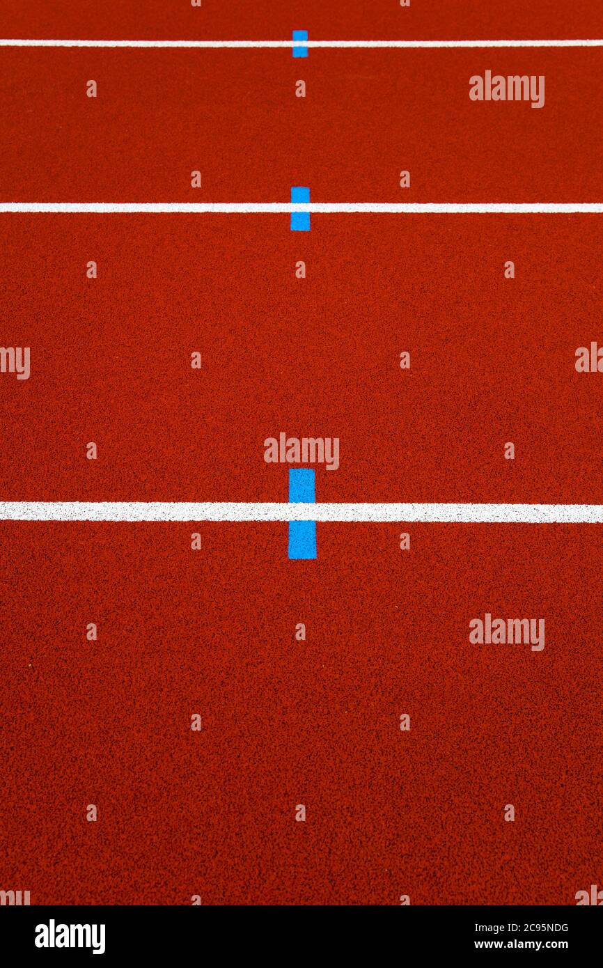 Closeup of the white lines on red stadium running track Stock Photo - Alamy