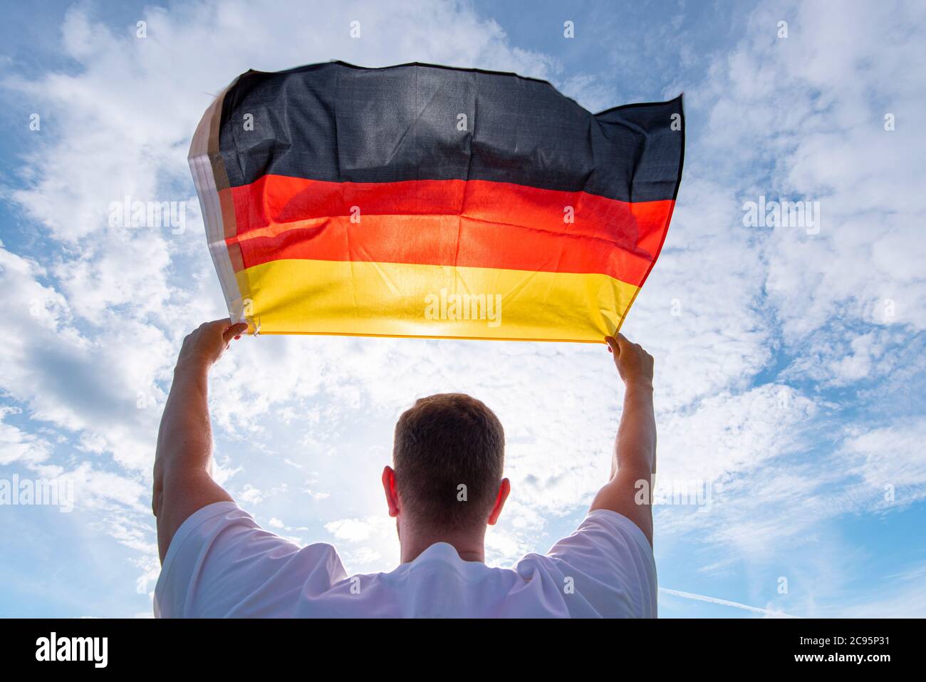 Man holding Flag of Germany, concept picture Stock Photo - Alamy
