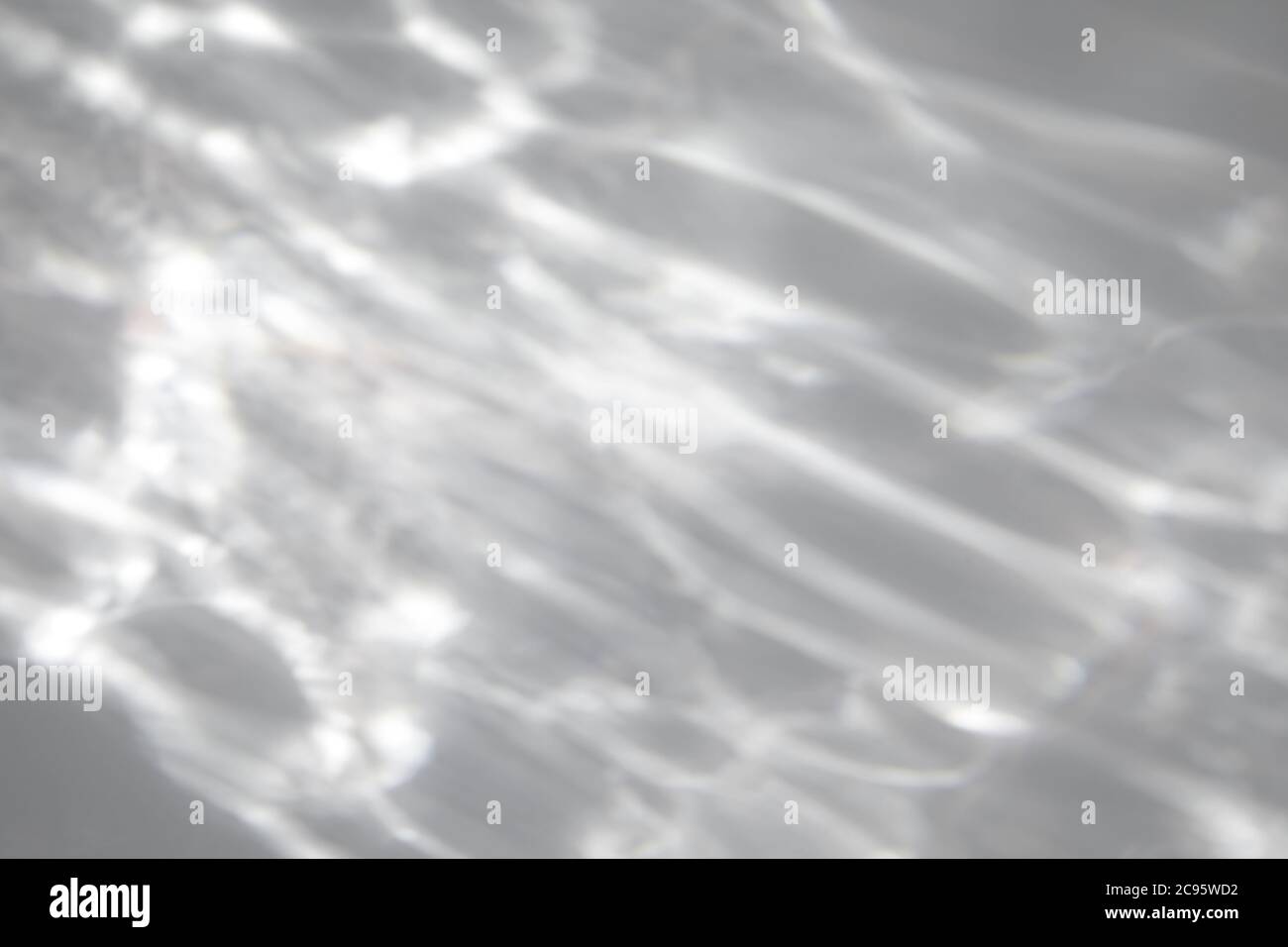 shadow and light caustic effect on a white wall Stock Photo - Alamy