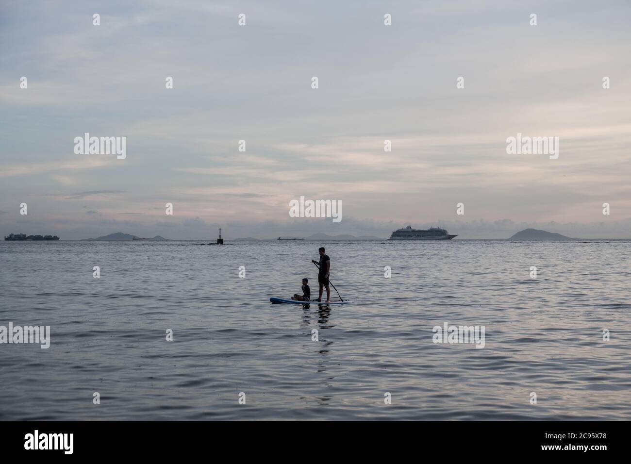 Hong Kong, China. 26th July, 2020. A man roams a paddle board at the ...