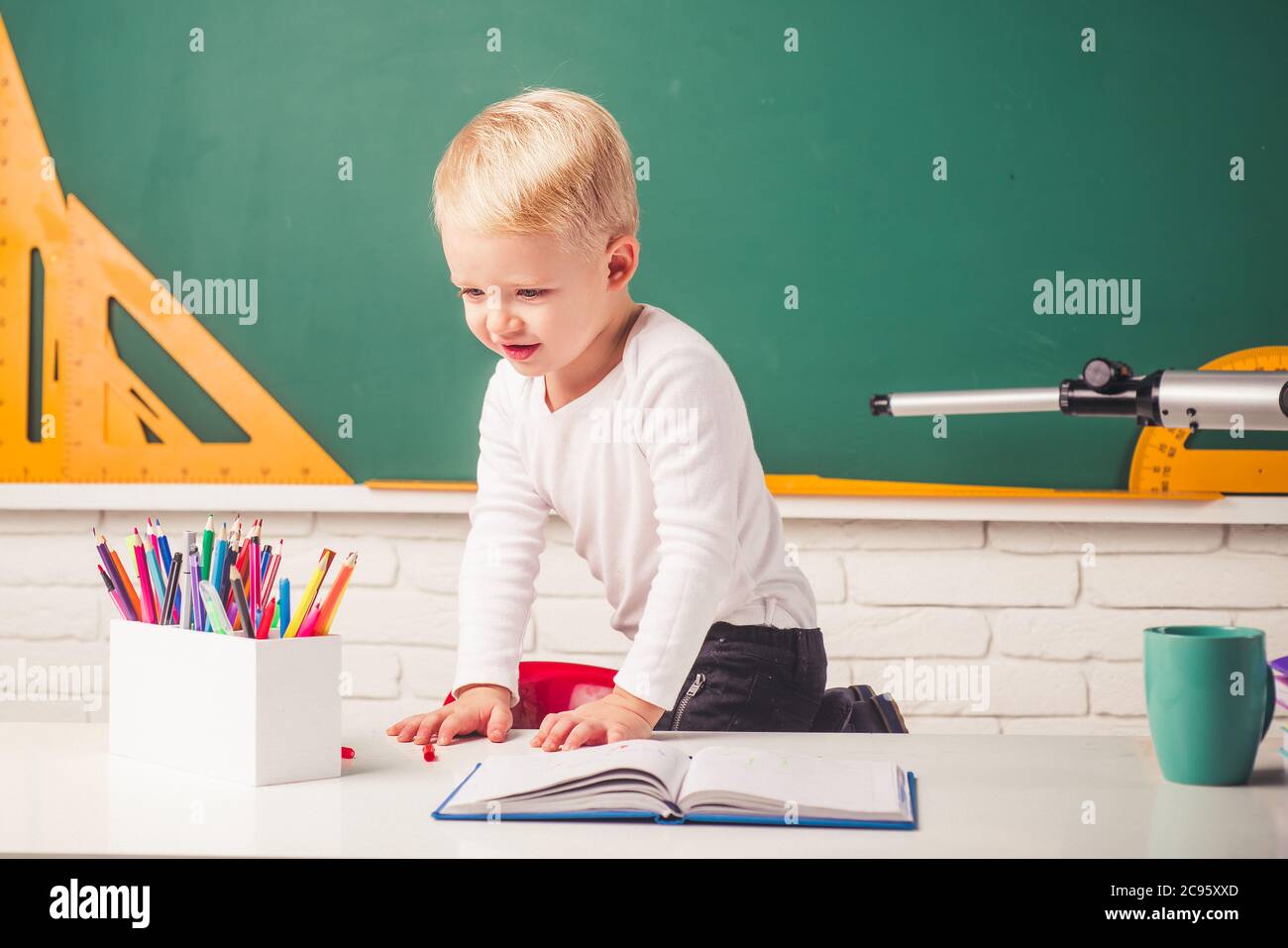 Pupil learning letters and numbers. Kids gets ready for school. Home ...
