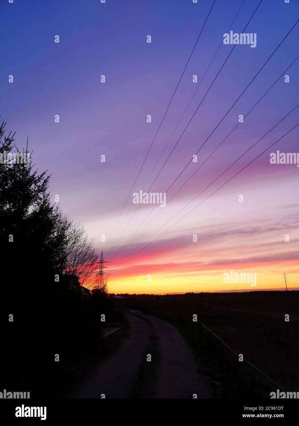 Sunset in the village. The sun went down low Stock Photo - Alamy