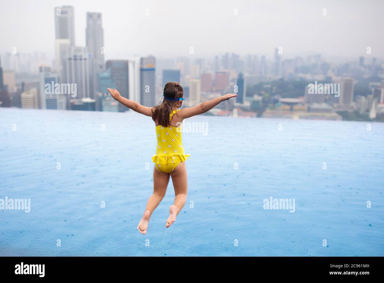 Children swimming in an infinity pool hi-res stock photography and ...