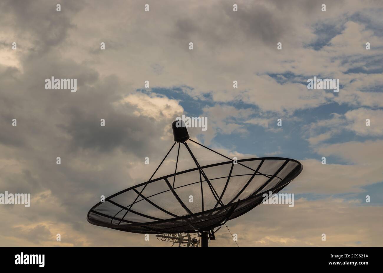 Black Satellite Dish Antenna Receiver Against on Blue Sky background ...