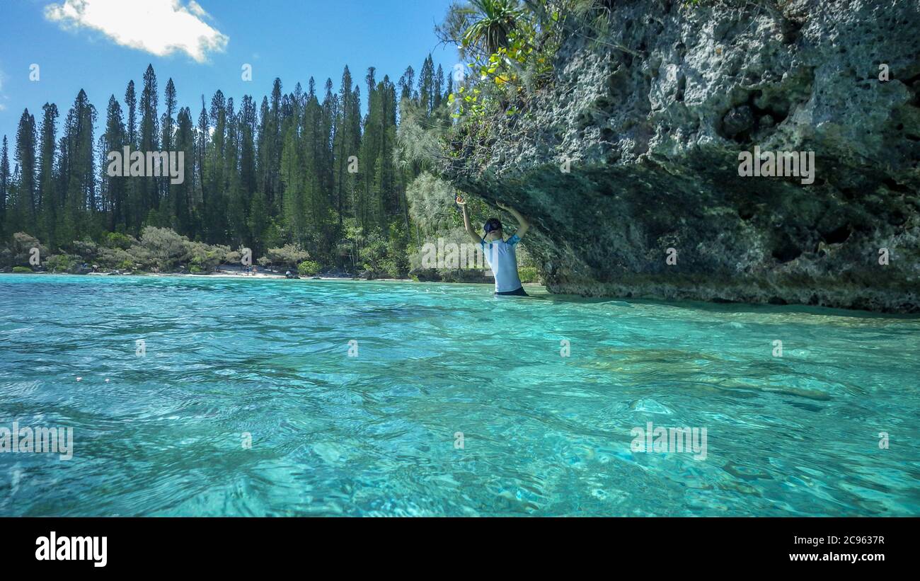 Young people snorkeling in natural swimming pool of Oro Bay, Isle of ...