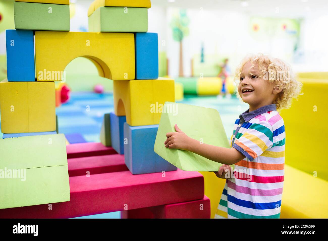 Child playing with colorful construction toy blocks. Educational toys ...
