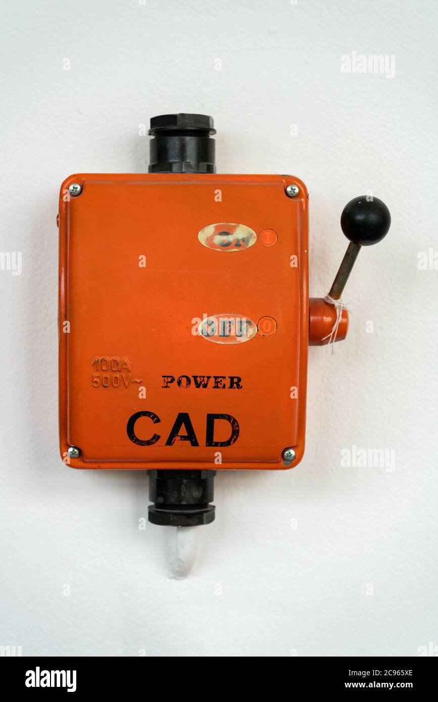 Orange colored vintage high voltage switch in a former factory for ...