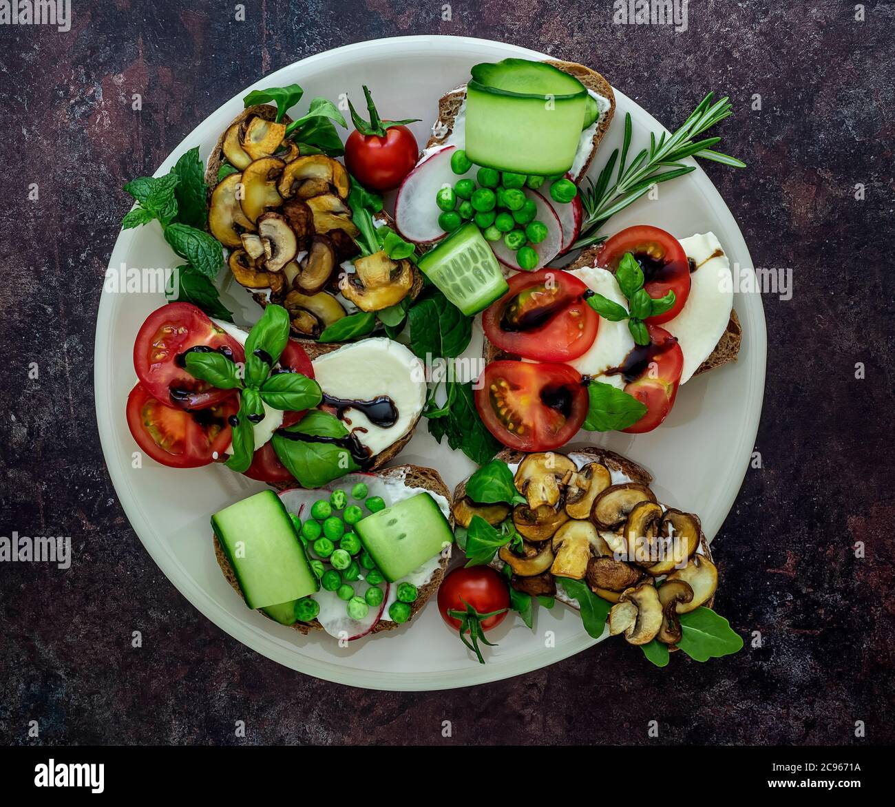 Plate with vegetarian sandwich toasts with different toppings, top view ...