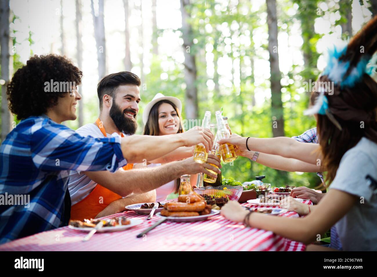 Friends having fun in nature doing bbq Stock Photo - Alamy