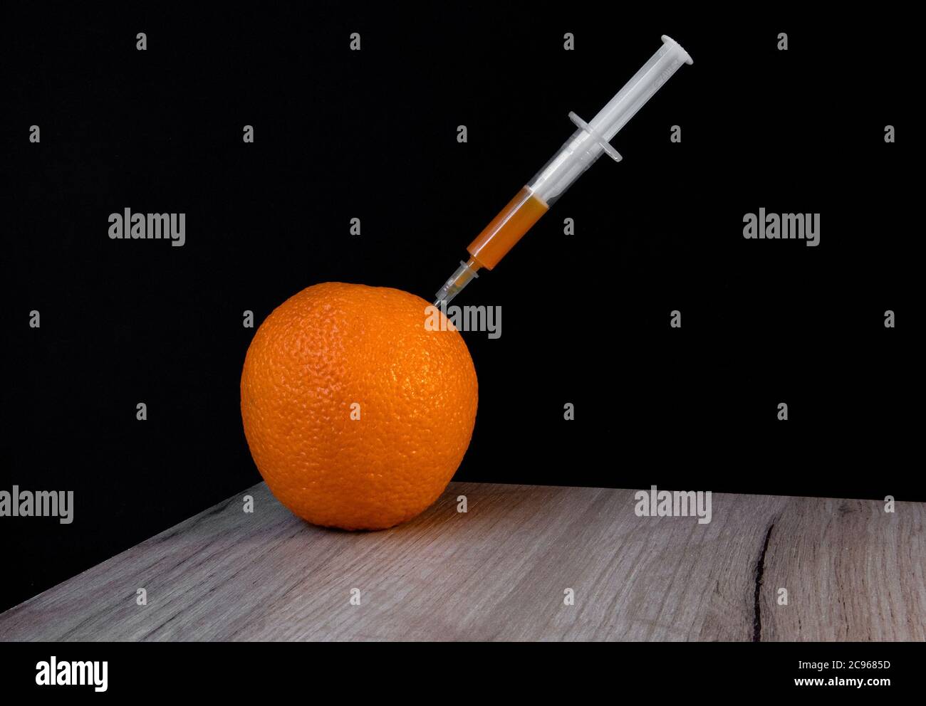Syringe injecting orange fruit hi-res stock photography and images - Alamy