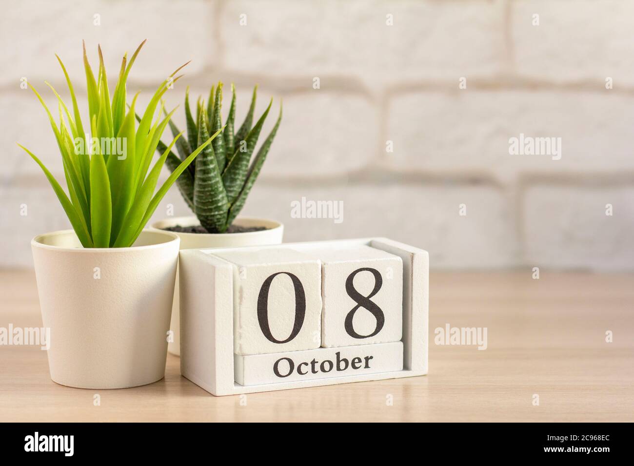 October 8 on a wooden calendar on a table or shelf.One day of the ...