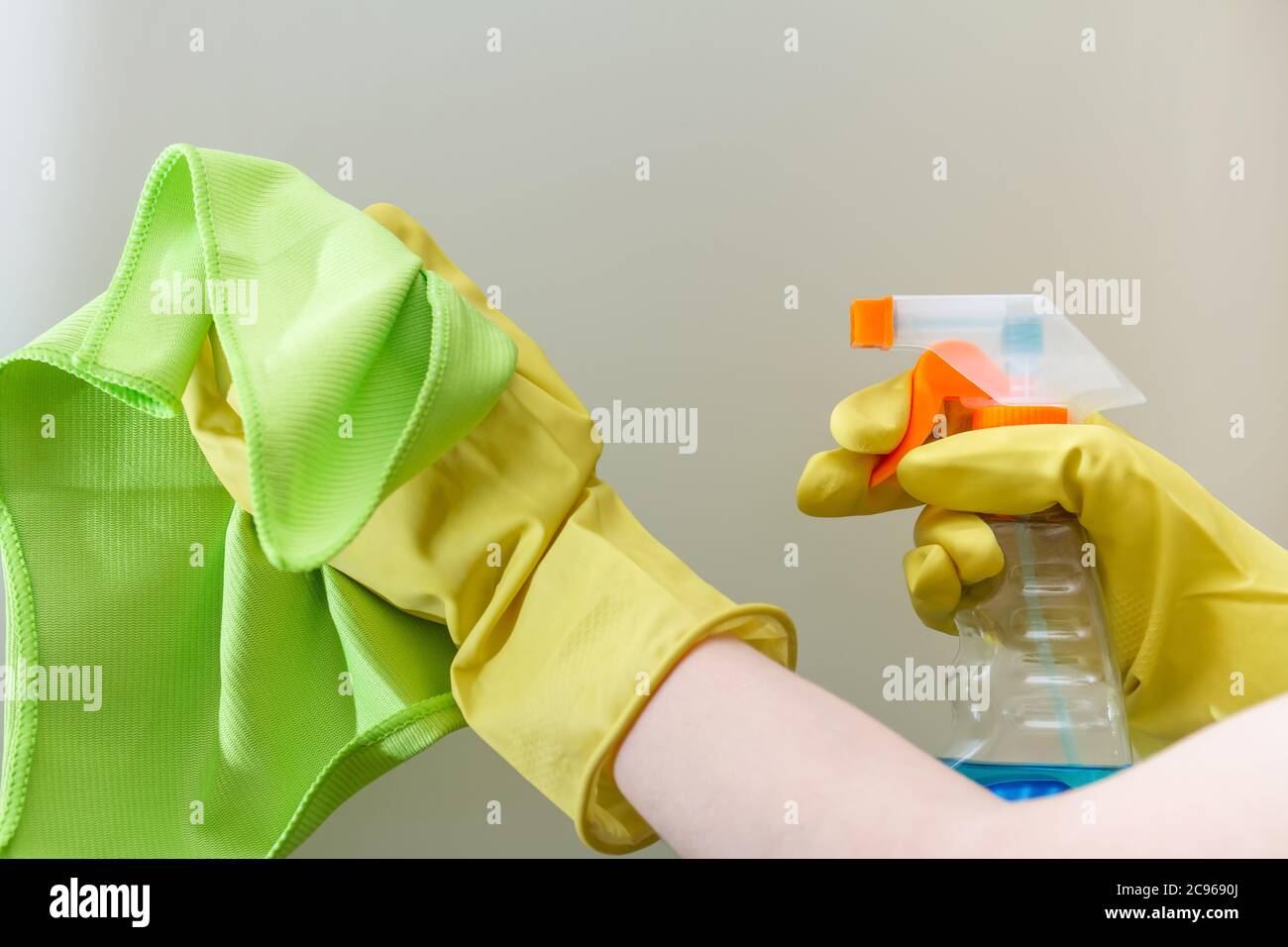 Hands with a duster and detergent cleaning the glass Stock Photo - Alamy