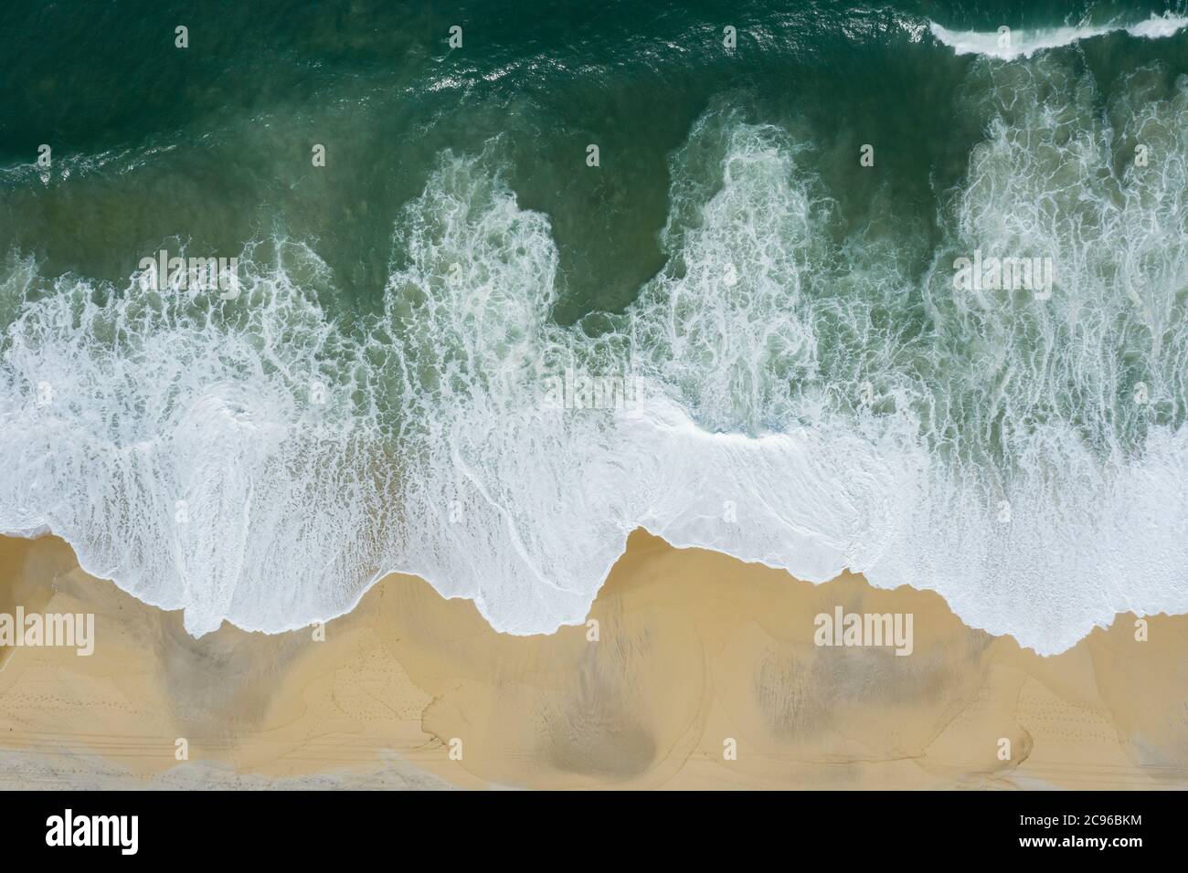 Wave and sand Stock Photo - Alamy