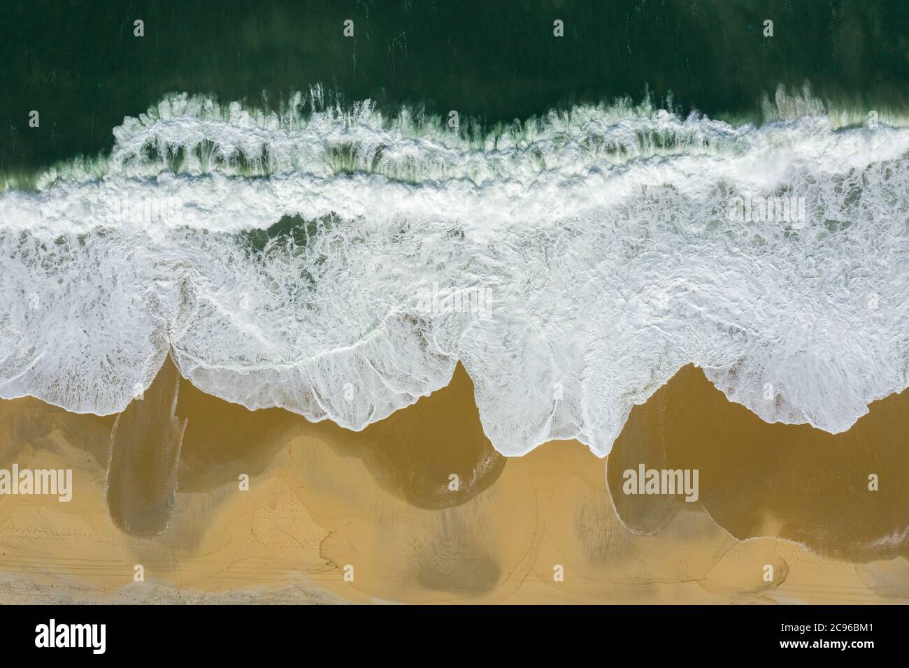 Wave and sand Stock Photo - Alamy