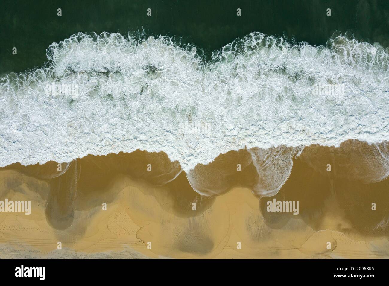 Wave and sand Stock Photo - Alamy