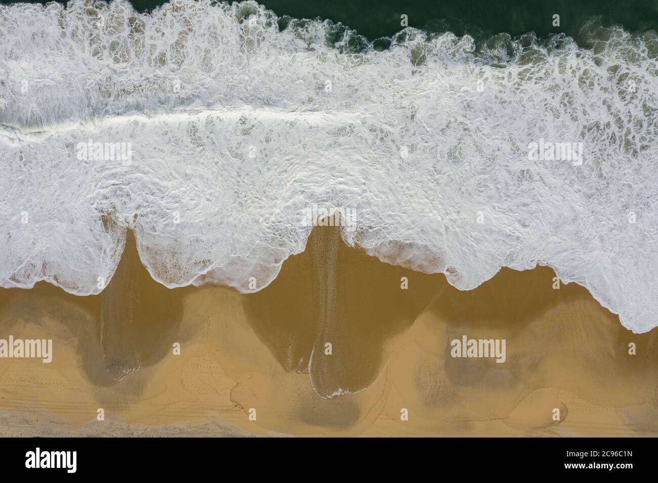 Wave and sand Stock Photo - Alamy