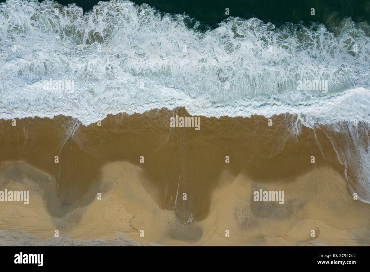Wave and sand Stock Photo - Alamy