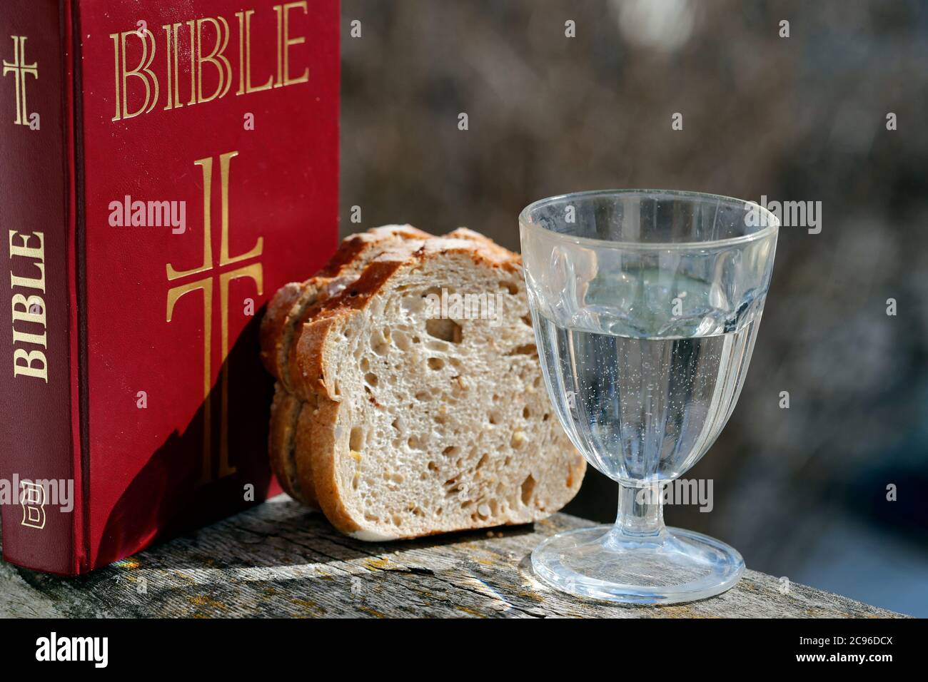 Bread, glass of water, and holy Bible during Lent. A solemn religious ...