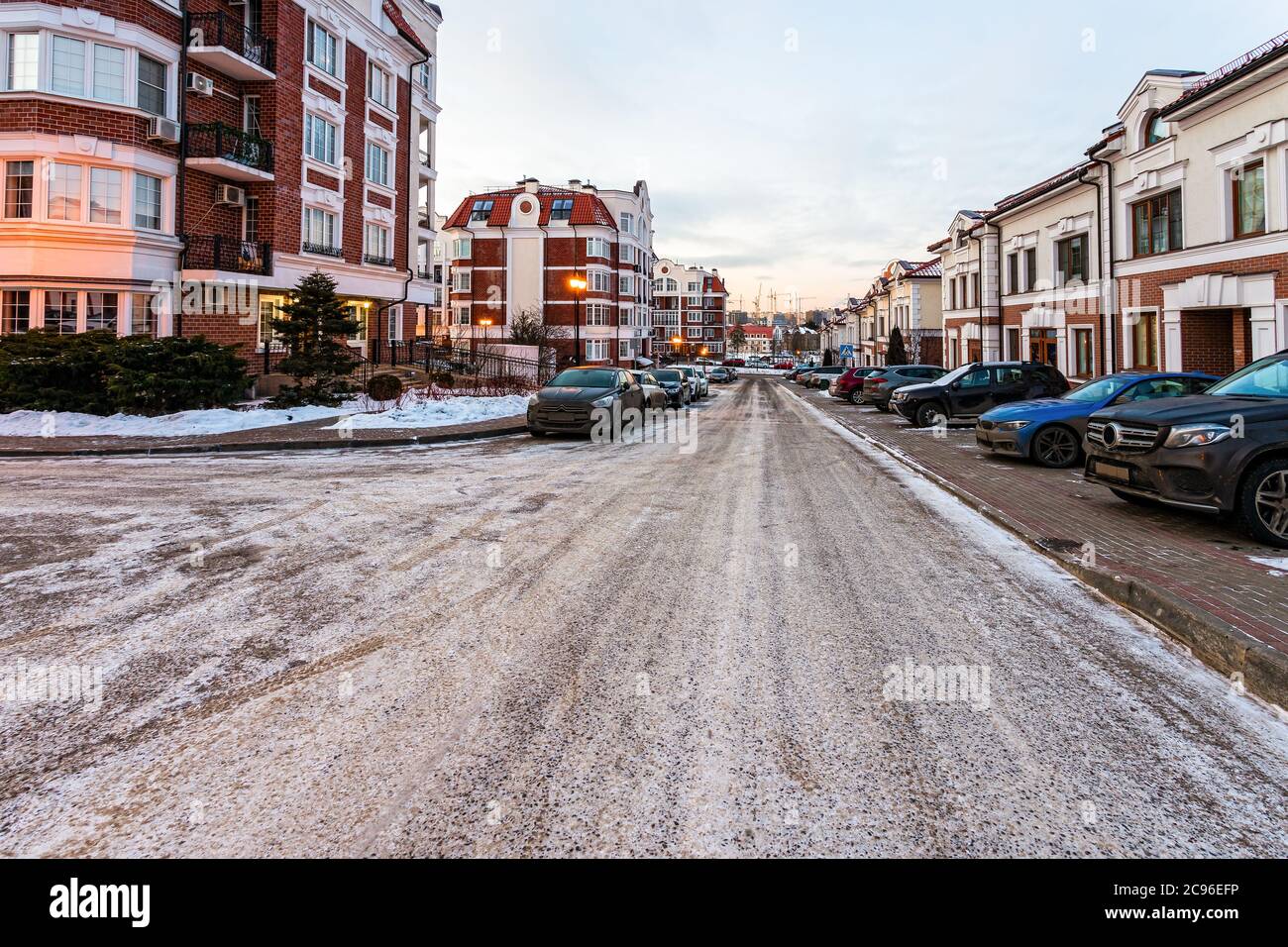 Empty city street, parked cars and road in snow in winter Stock Photo ...