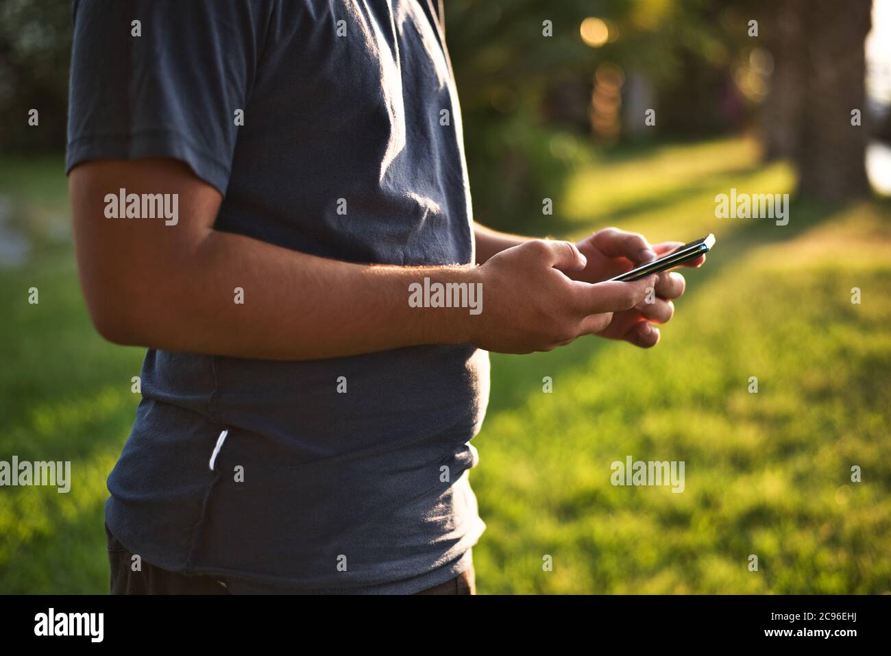 Teenage Boy Using Phone In Urban Setting Stock Photo - Alamy