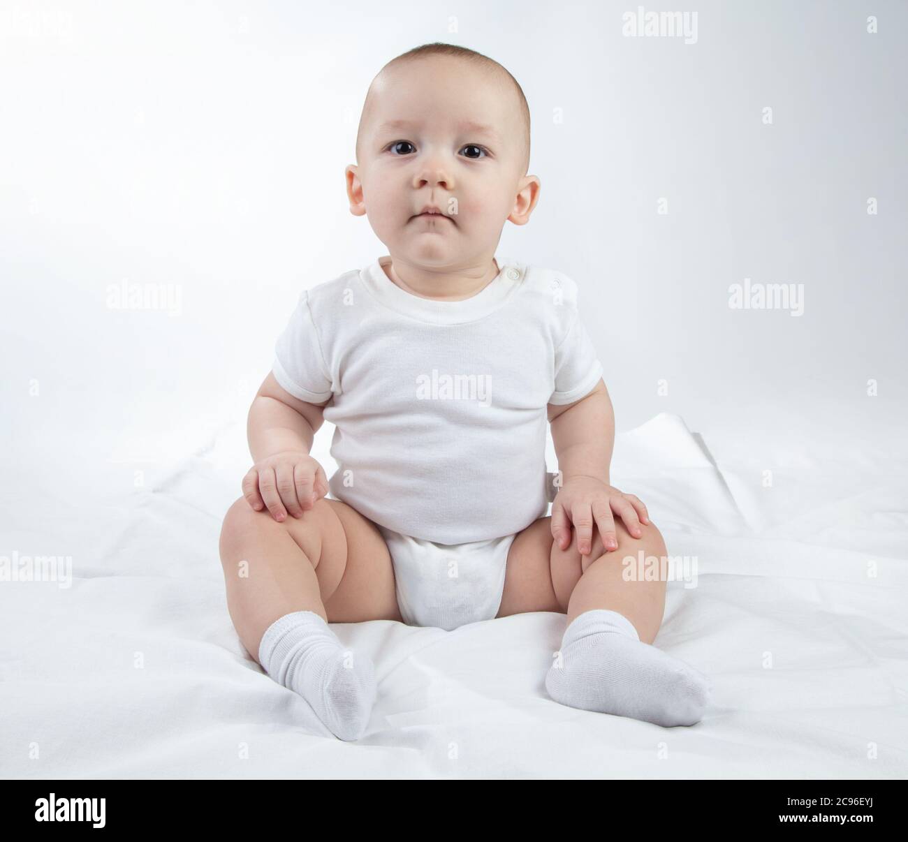 Photo a nine-month-old baby on a white background Stock Photo - Alamy