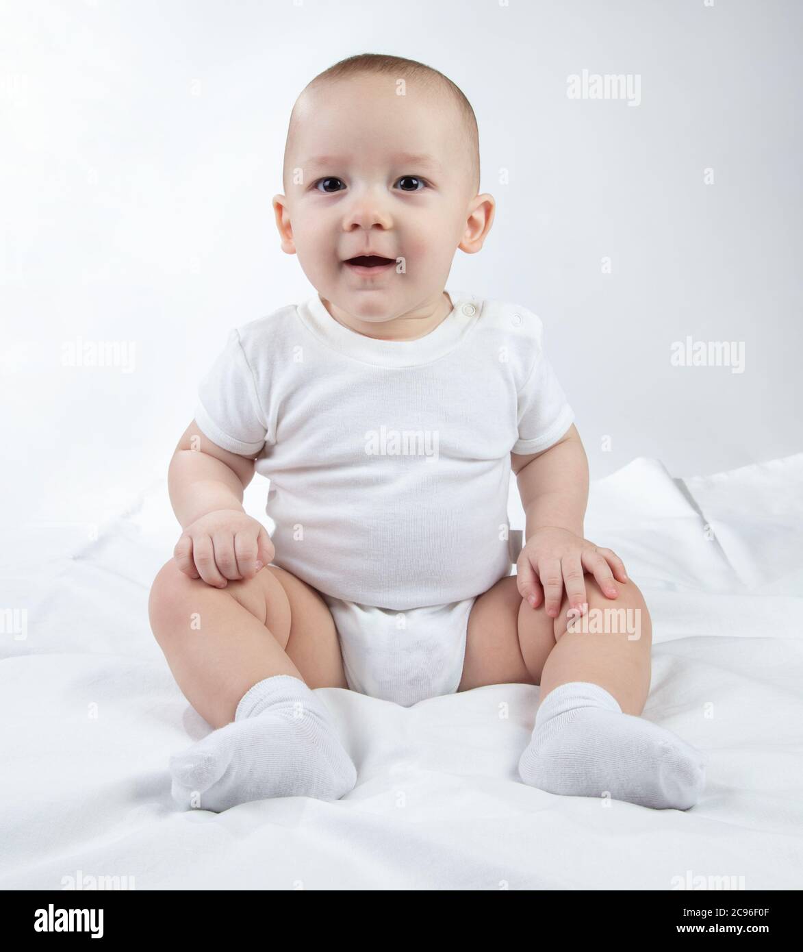 Image of a sitting nine-month-old baby on a white background Stock ...