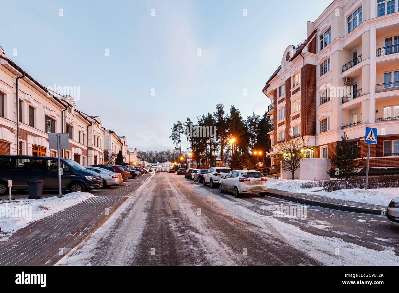 Empty city street, parked cars and road in snow in winter Stock Photo ...