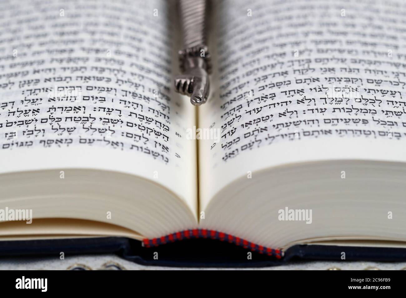 A silver Yad Jewish ritual pointer on a Torah. France Stock Photo - Alamy