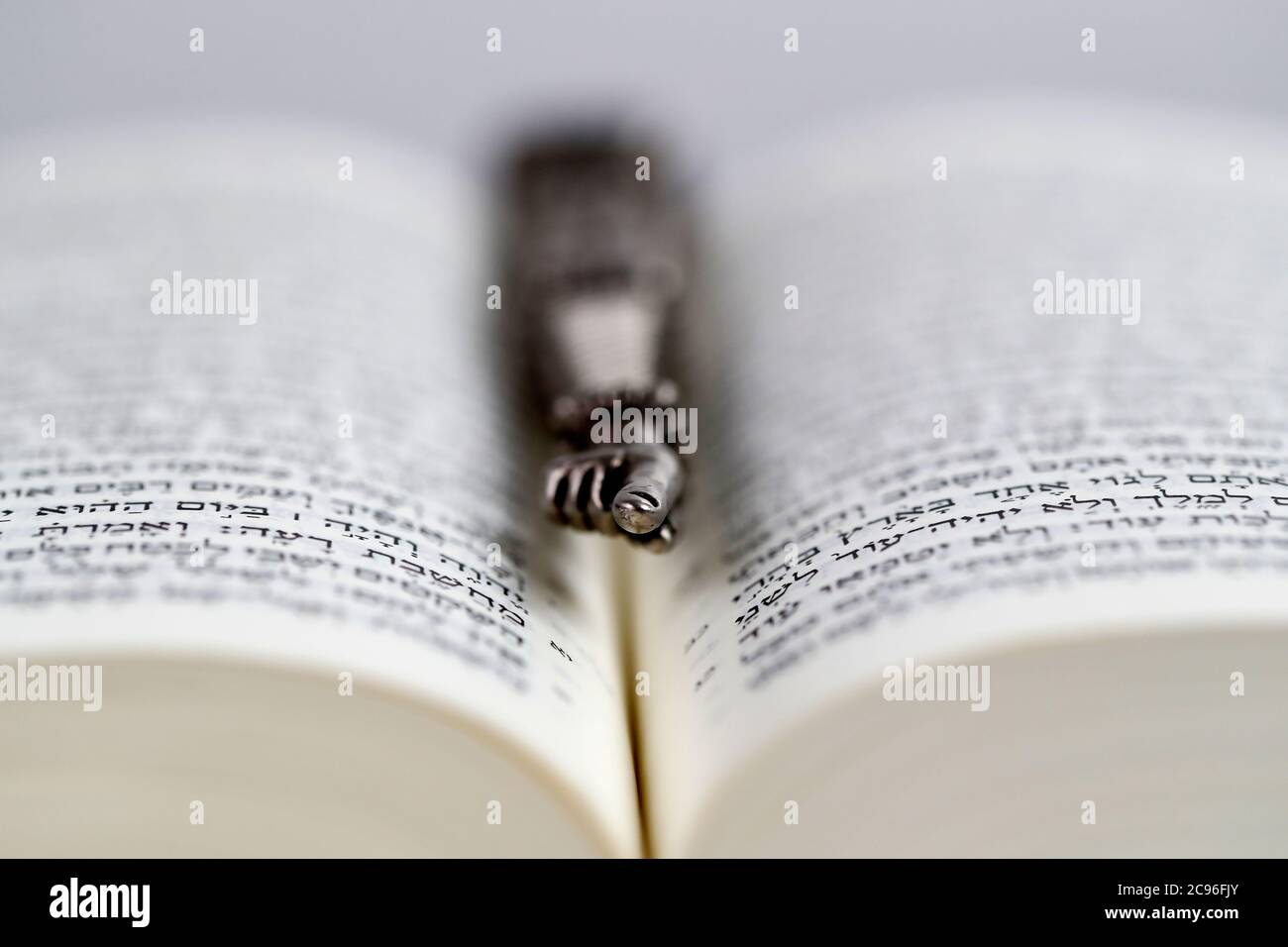 A silver Yad Jewish ritual pointer on a Torah. France Stock Photo - Alamy