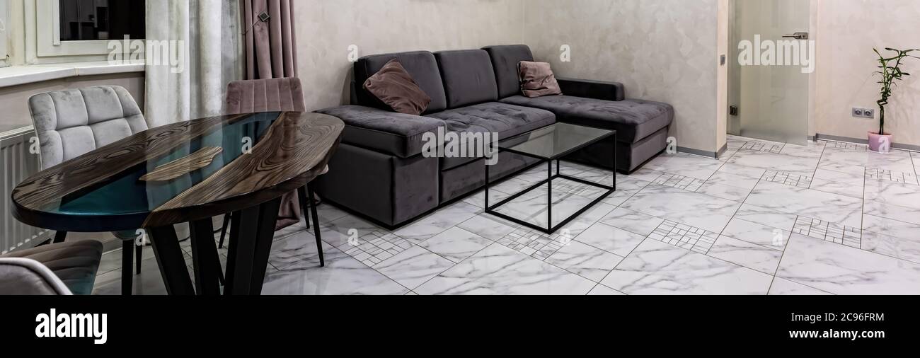 Modern interior of a large and cozy living room with a sofa and a table ...