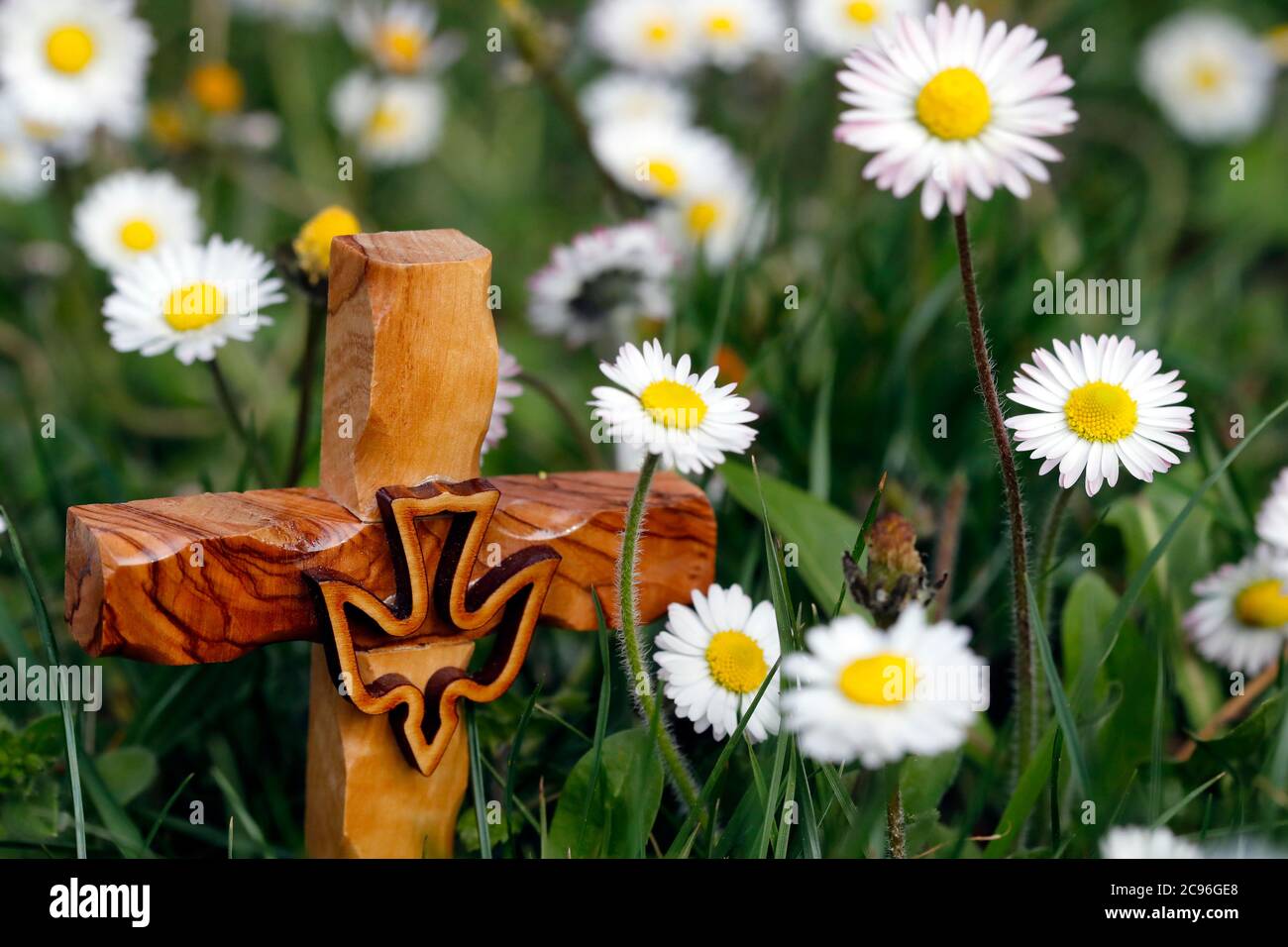 Wooden cross on the grass with flowers. France Stock Photo - Alamy