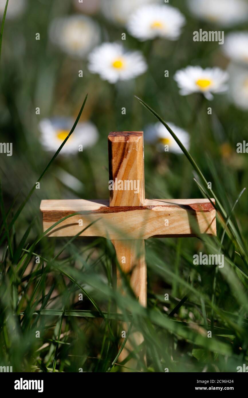 Wooden cross on the grass with flowers. France Stock Photo - Alamy